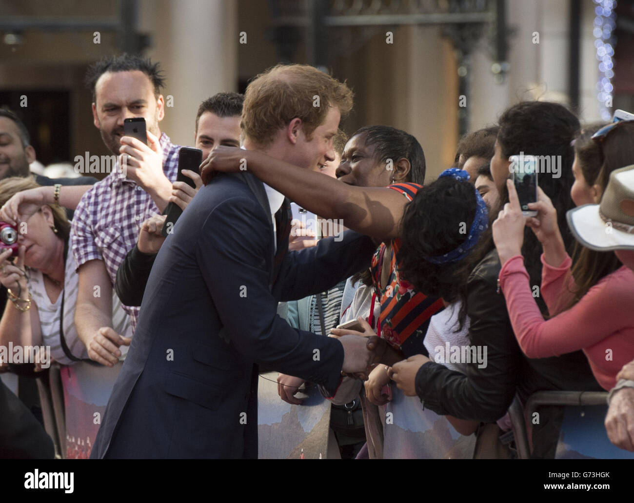 Prince Harry receives a hug from a fan as he attends the 50th ...