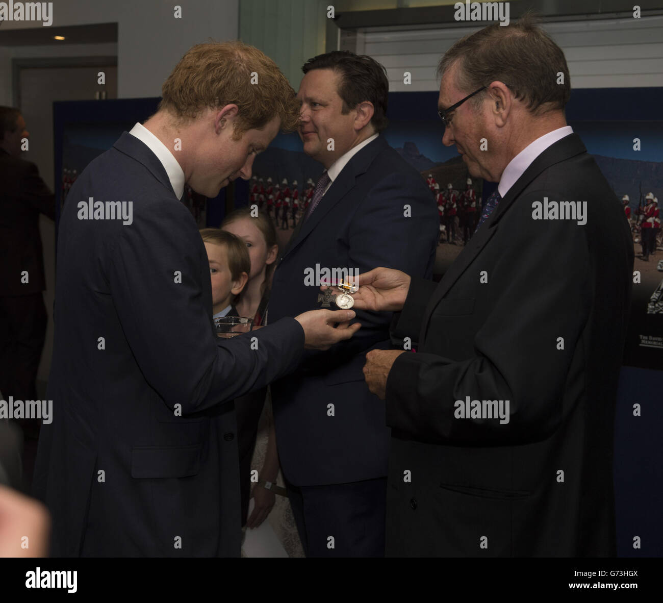 Prince Harry talks to Lord Ashcroft whilst being shown medals awarded ...