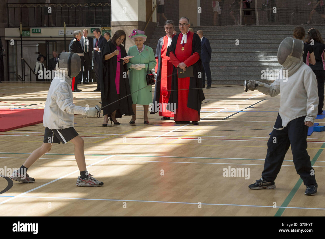 Queen Elizabeth II watches pupils taking part in fencing in the new ...