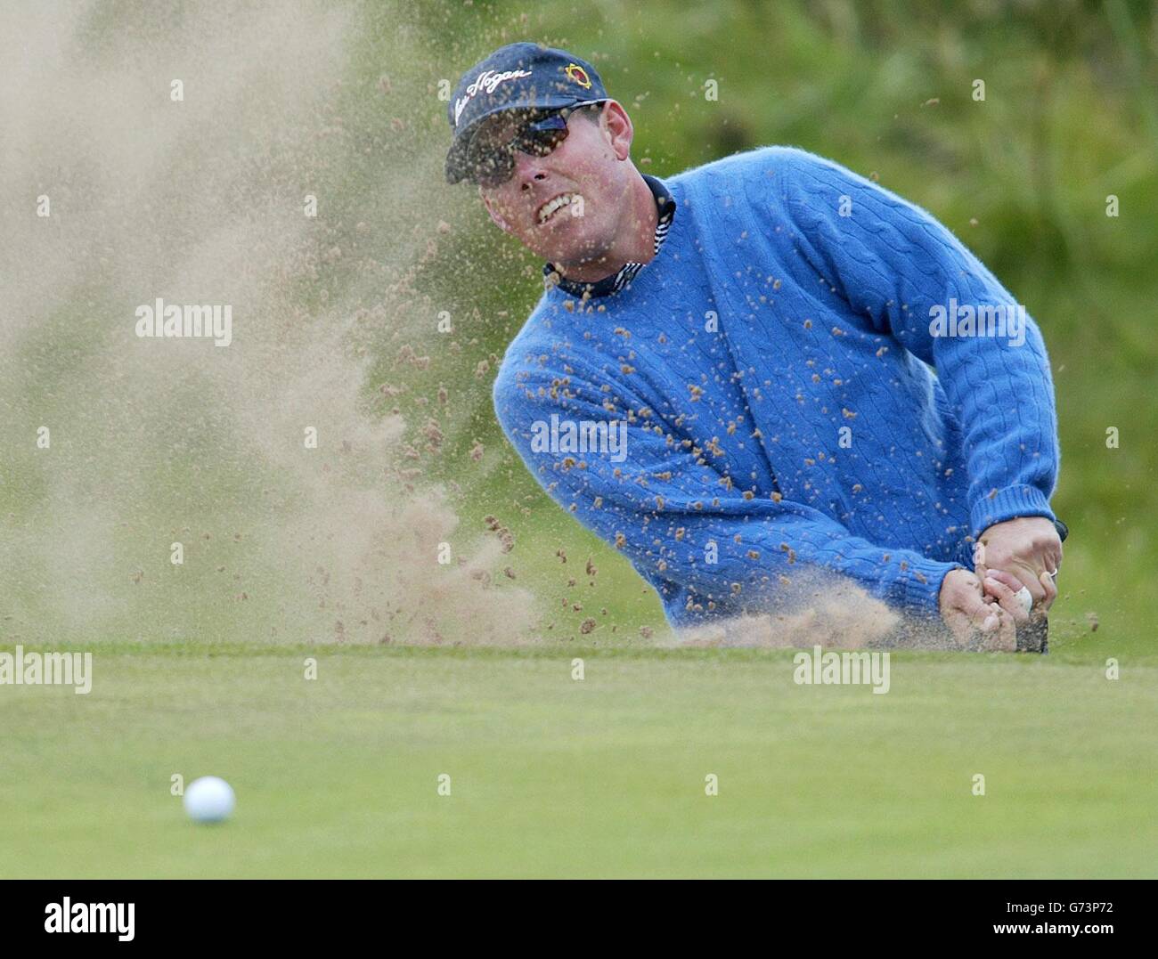 Jason Leonard from the USA practices in a bunker on the 4th green ...