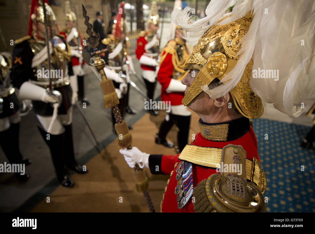A Gentleman at Arms stands to attention as soldiers from the Household ...