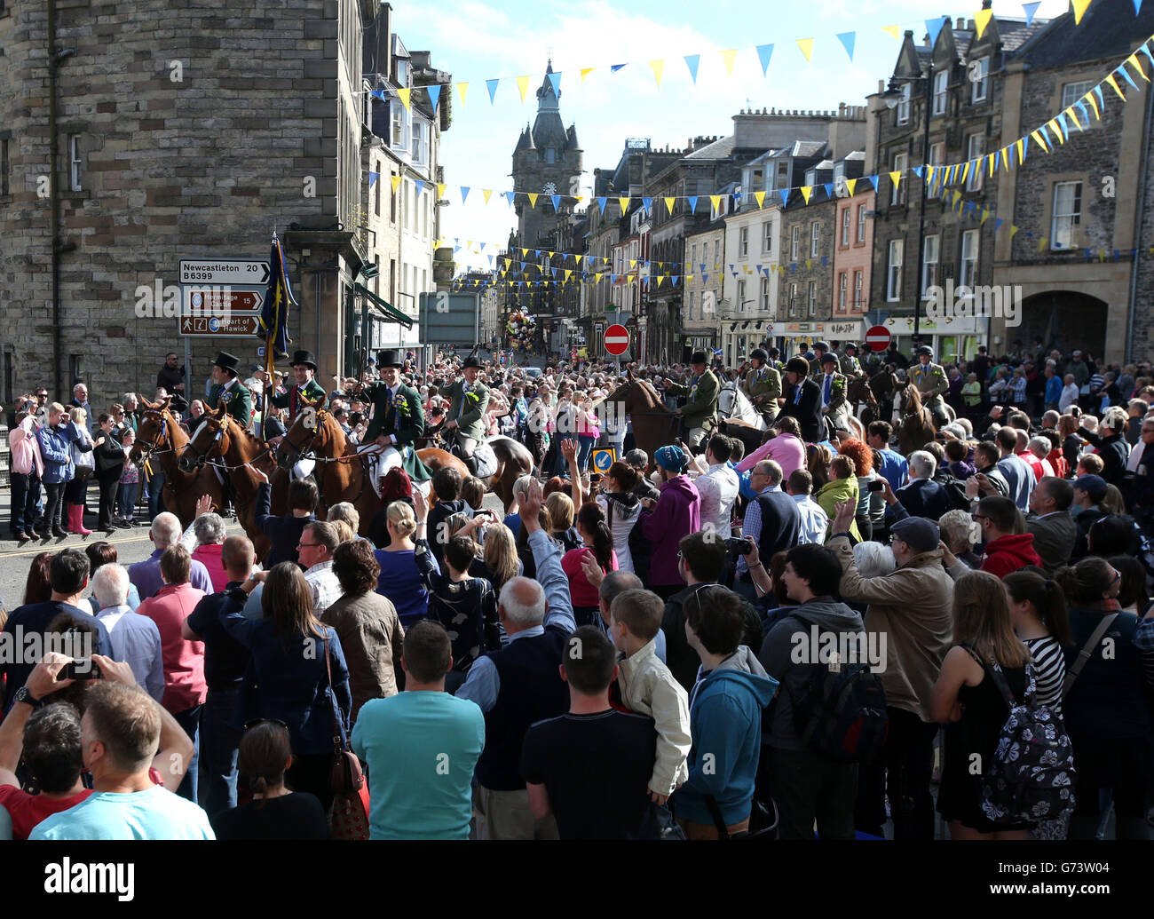 Cornet Ross Gibson carries the flag through the town centre as he leads ...