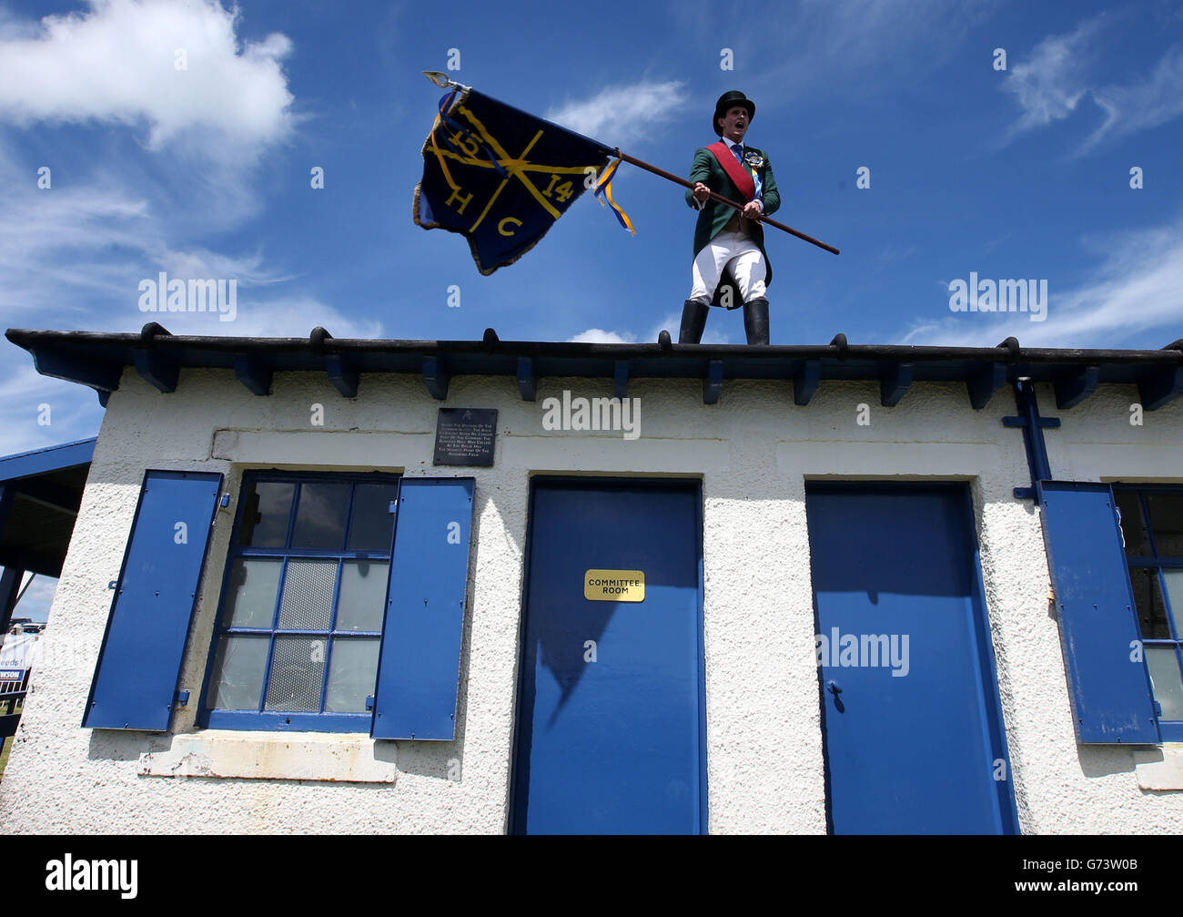 Cornet Ross Gibson waves the flag to the crowd after arriving at the ...
