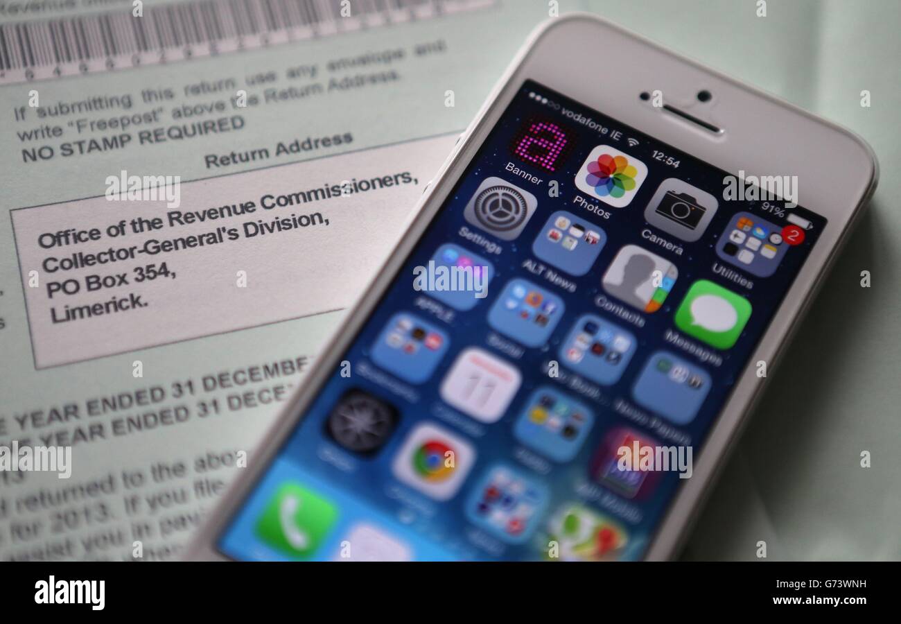 An Apple iPhone beside a tax return form as the Irish Government has ...