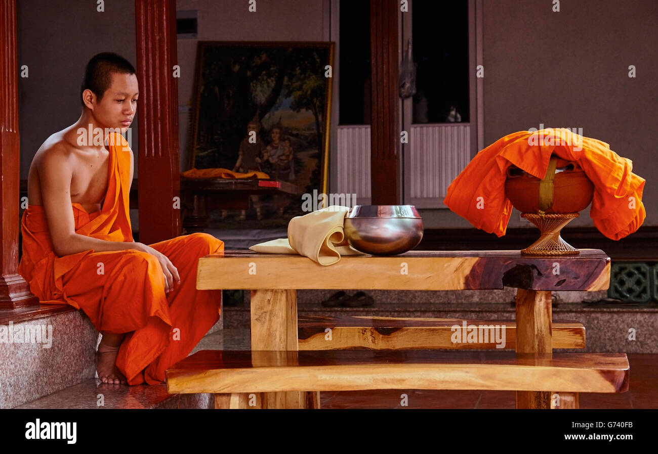 A young monk resting after collecting alms, Thailand Stock Photo - Alamy