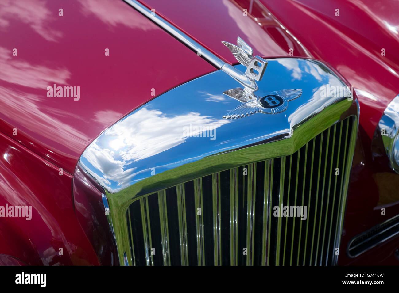 Close up of the front of a Red Bentley featuring the Bentley Badge ...