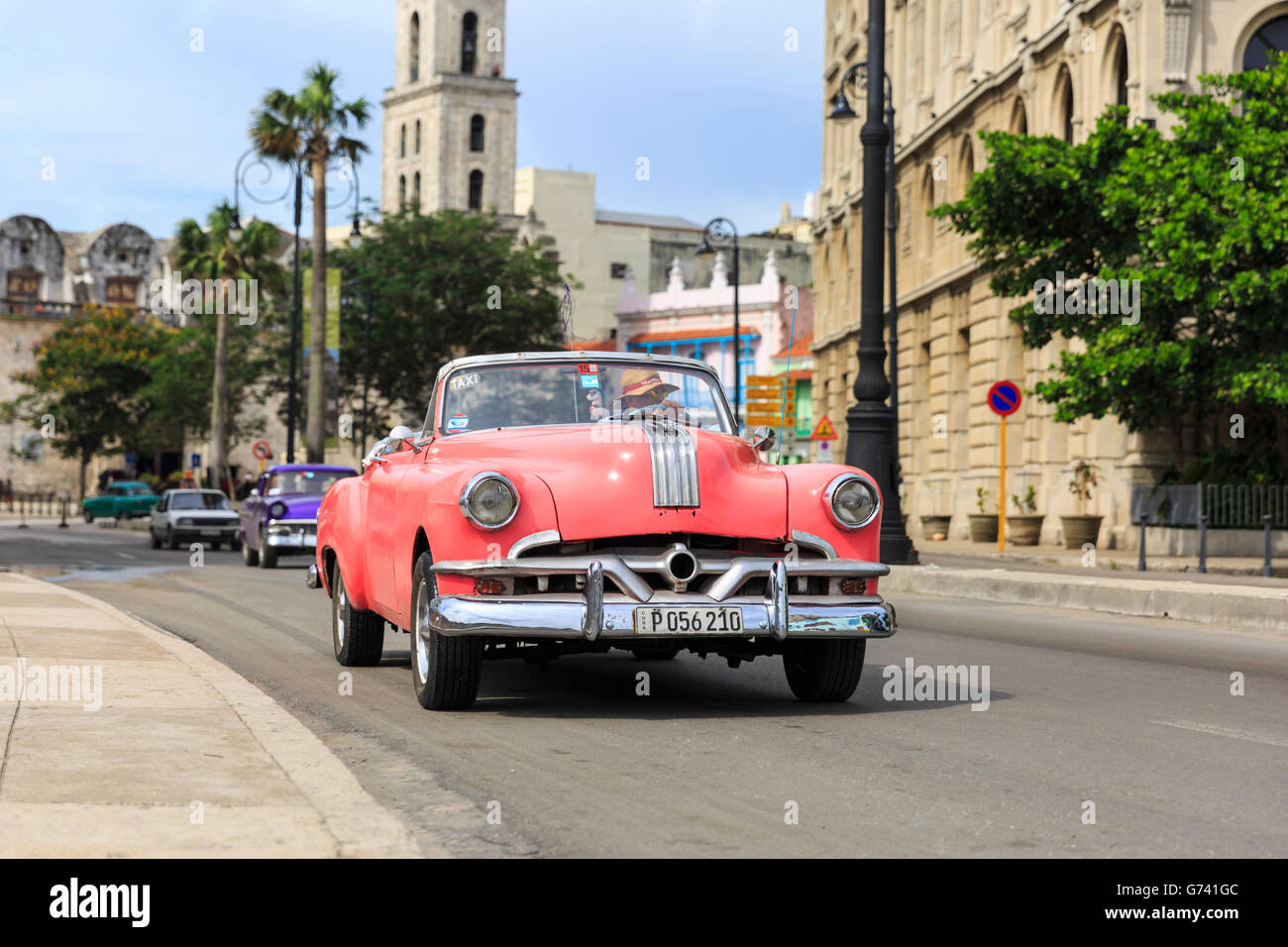 Pink American 1950s Pontiac convertible classic car taxi driving in ...