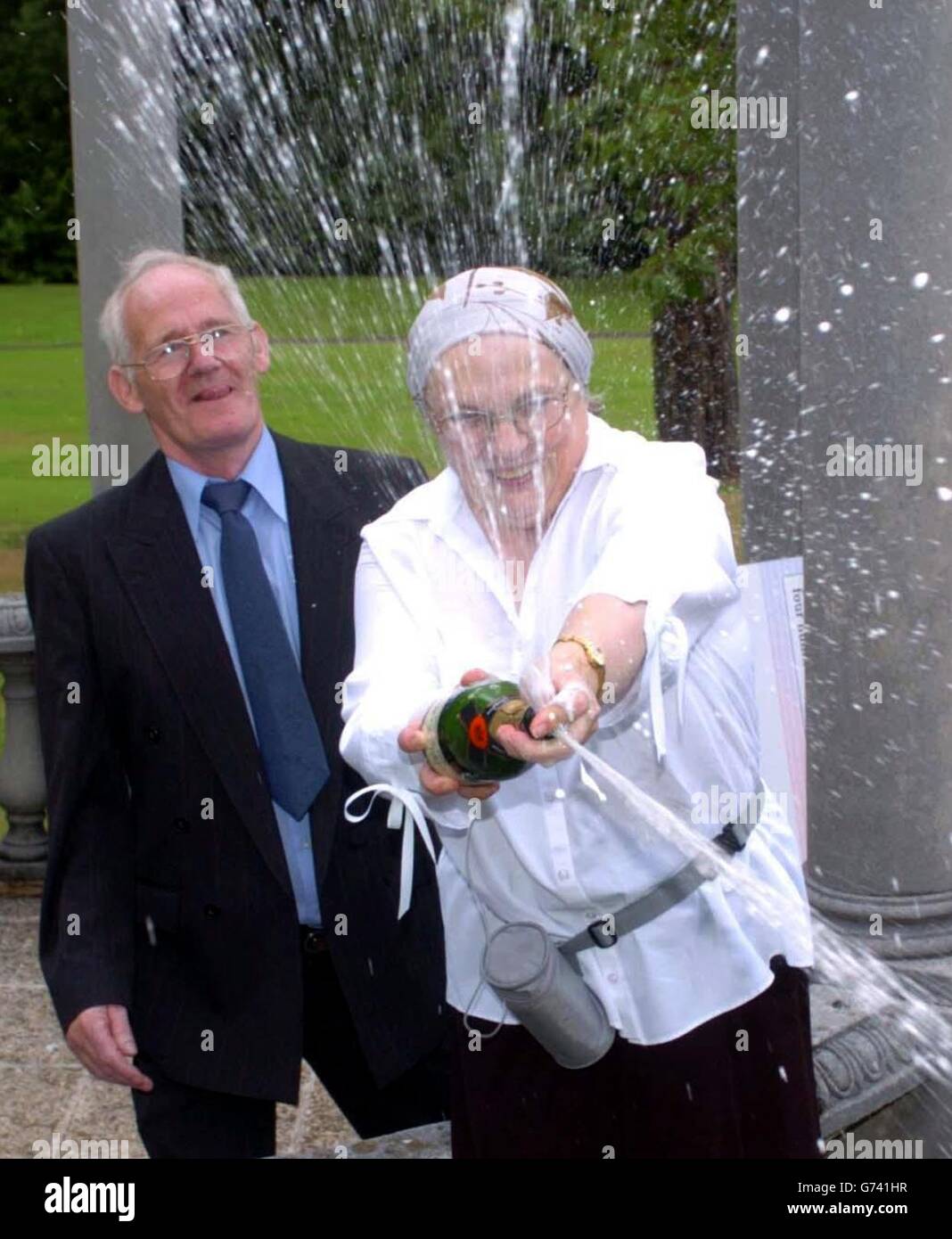 Housewife, Iris Jeffrey (58) sprays a bottle of champagne as husband ...