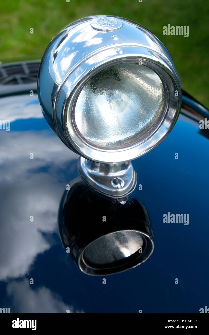 Old Chromium lamp on the wing od a Rolls Royce with clouds reflecting ... Old Chromium lamp on the wing od a Rolls Royce with clouds reflecting ...