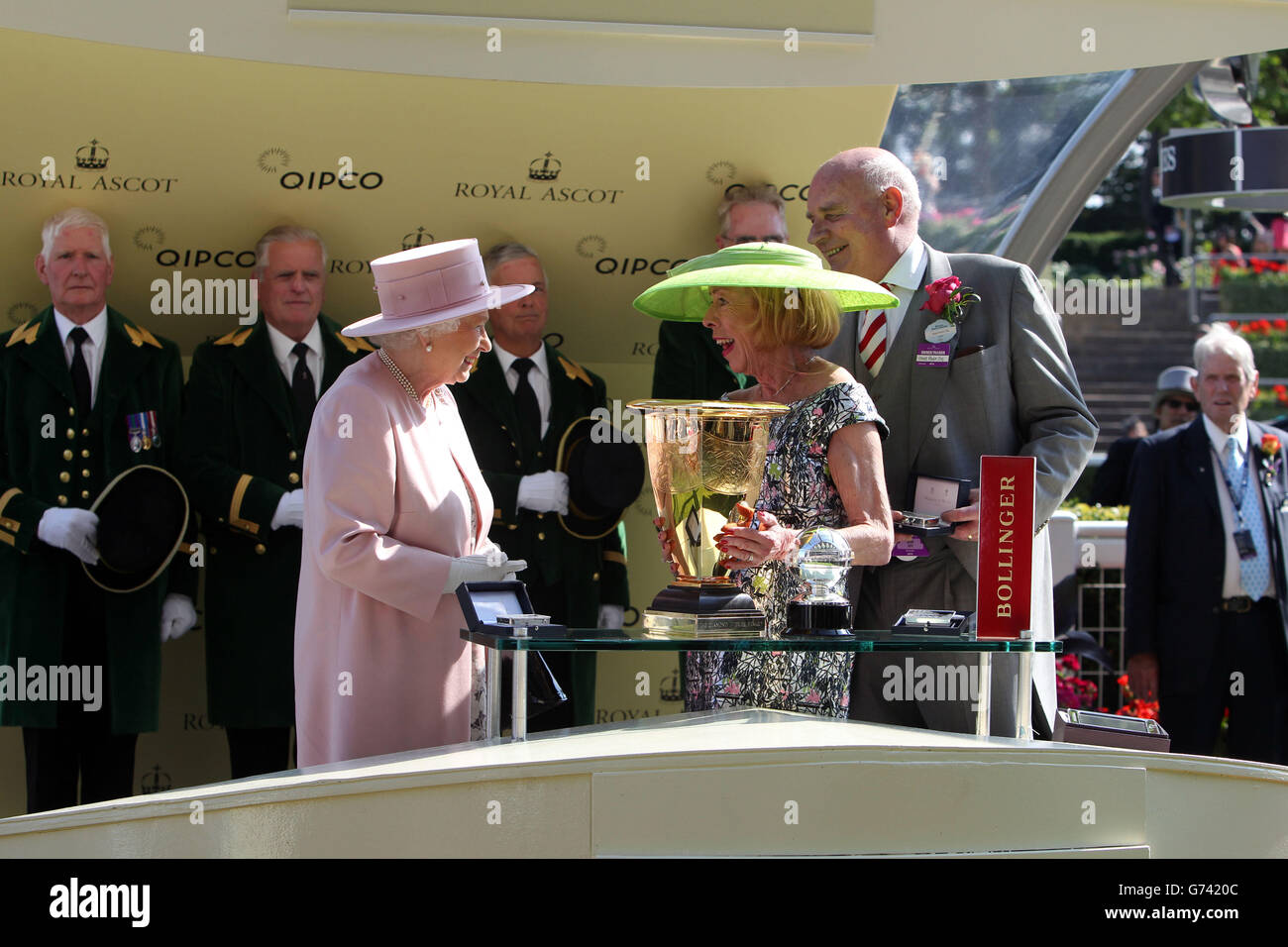 Queen Elizabeth II presents to the winning owner of Slade Power ridden ...