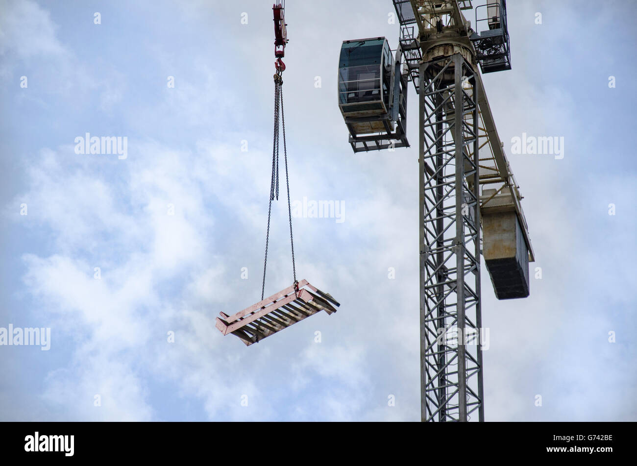 Crane lifting construction materials at site hi-res stock photography ...
