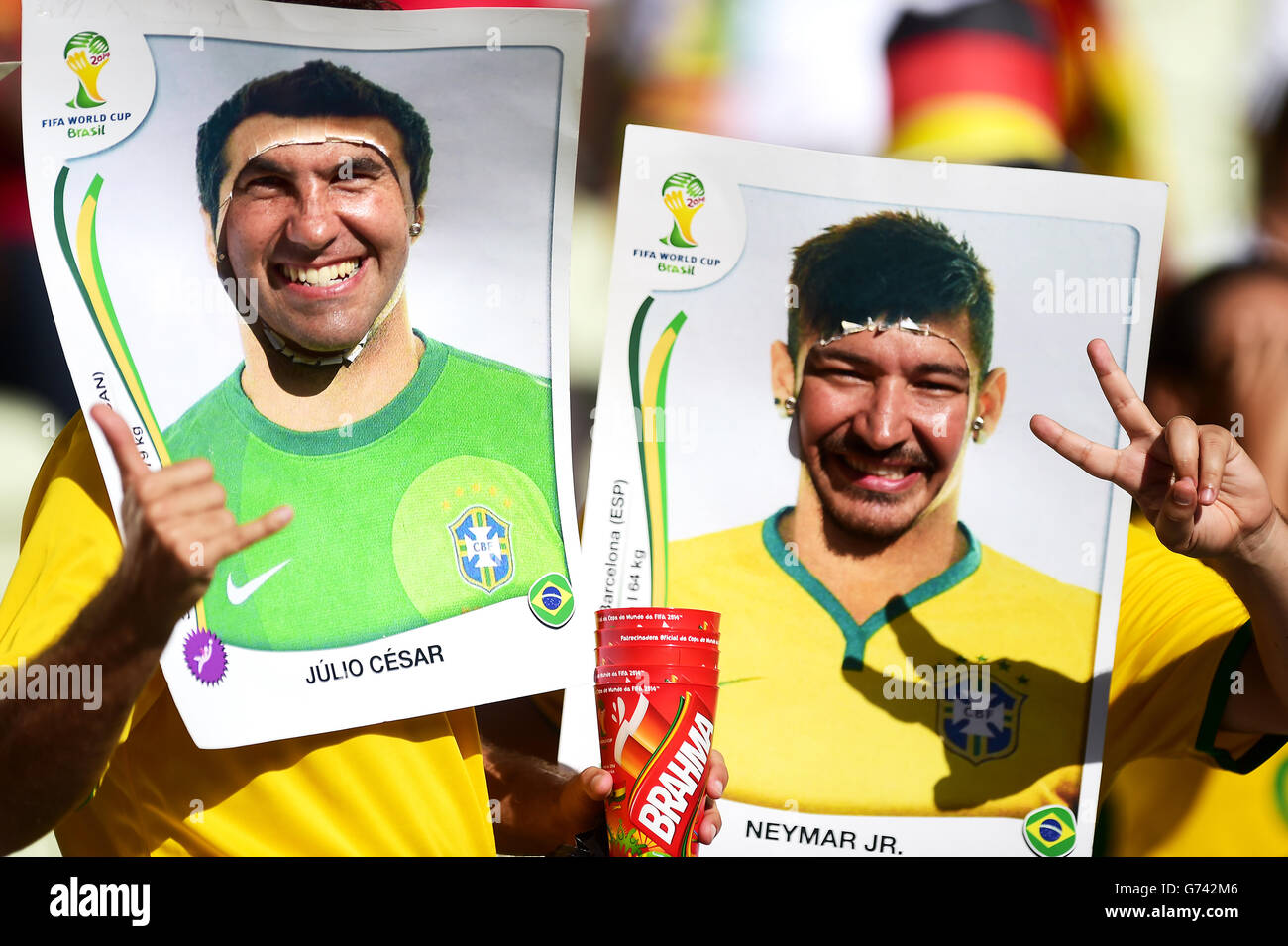 Fans in the stands poke their heads through giant panini style posters ...