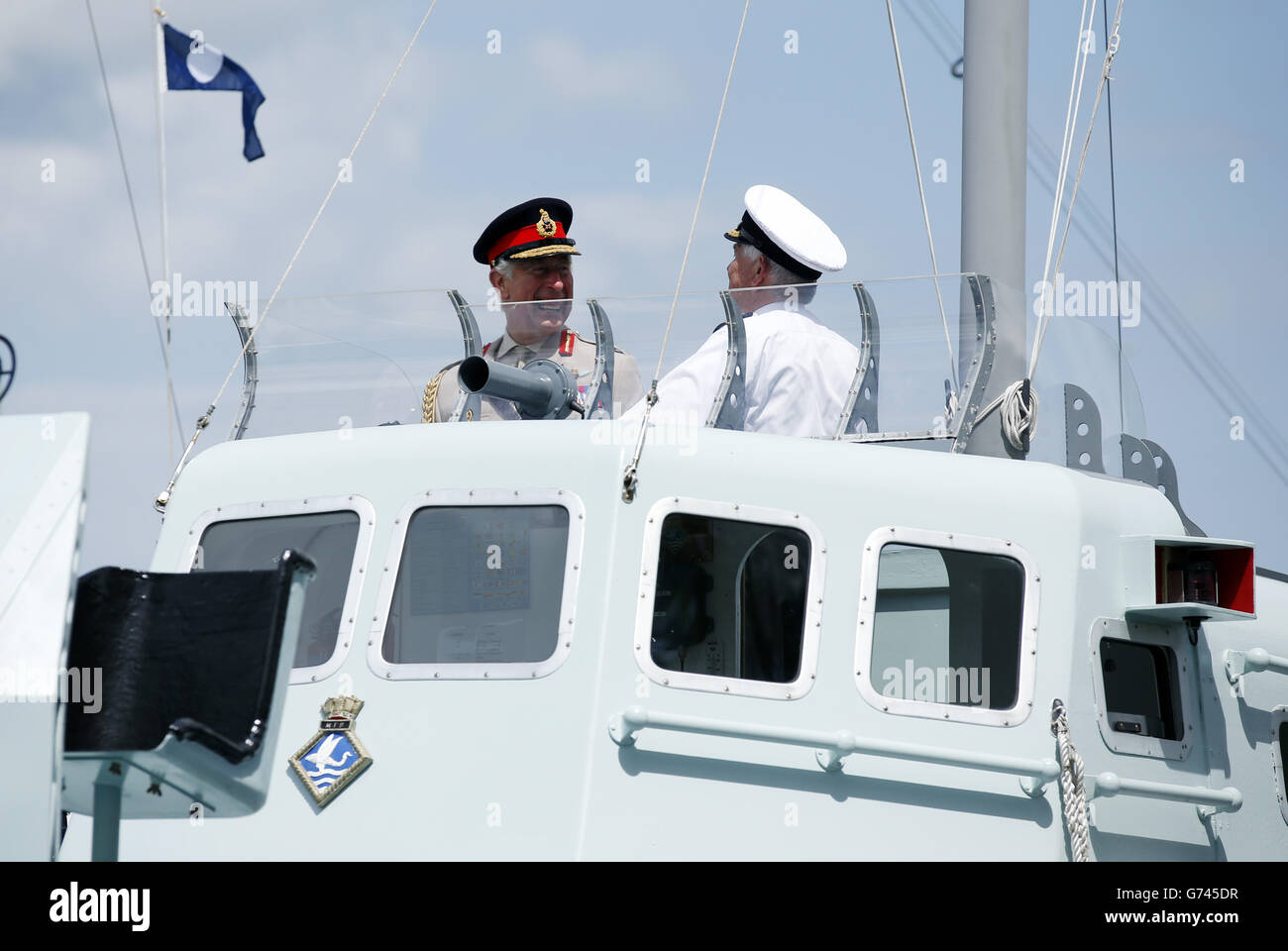 The Prince of Wales stands on the top deck of a Motor Gunboat (MGB) 81 ...