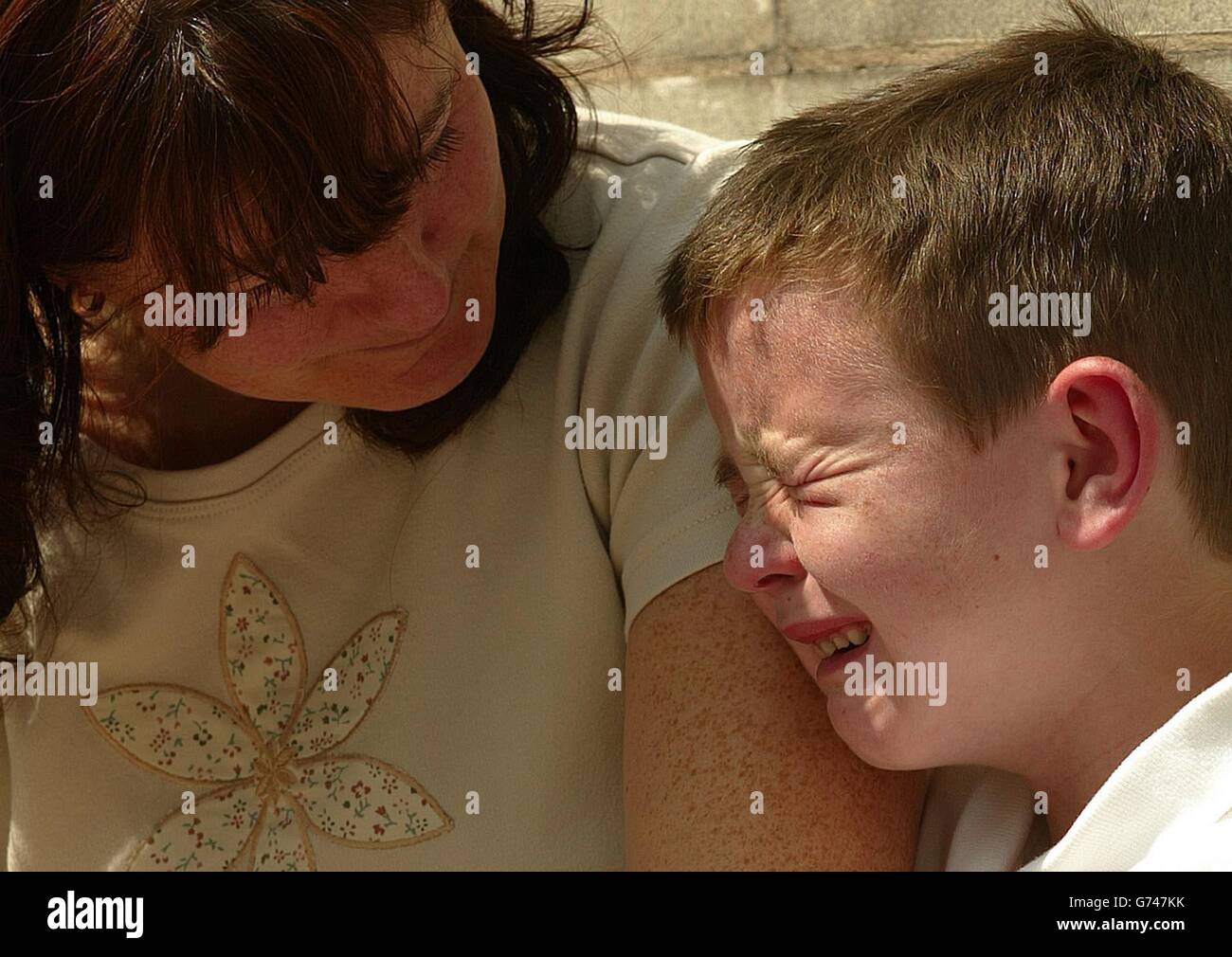 Carol Phillips tries to console her 8-year-old son Tomos outside ...