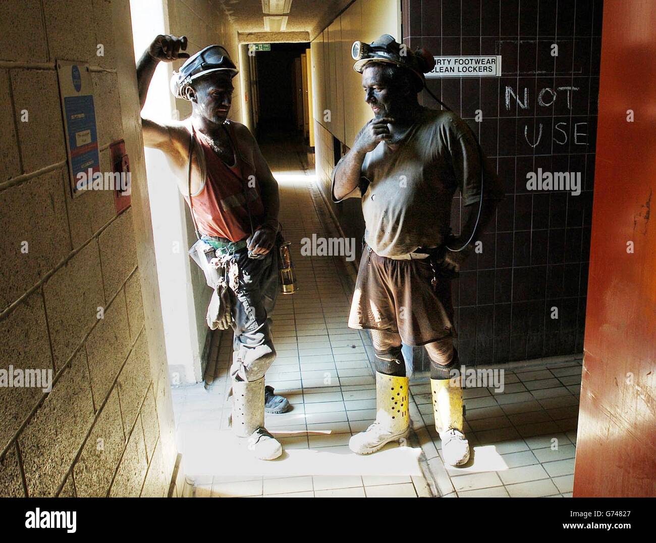 Two face workers stand in a locker room at Stillingfleet Colliery, York ...