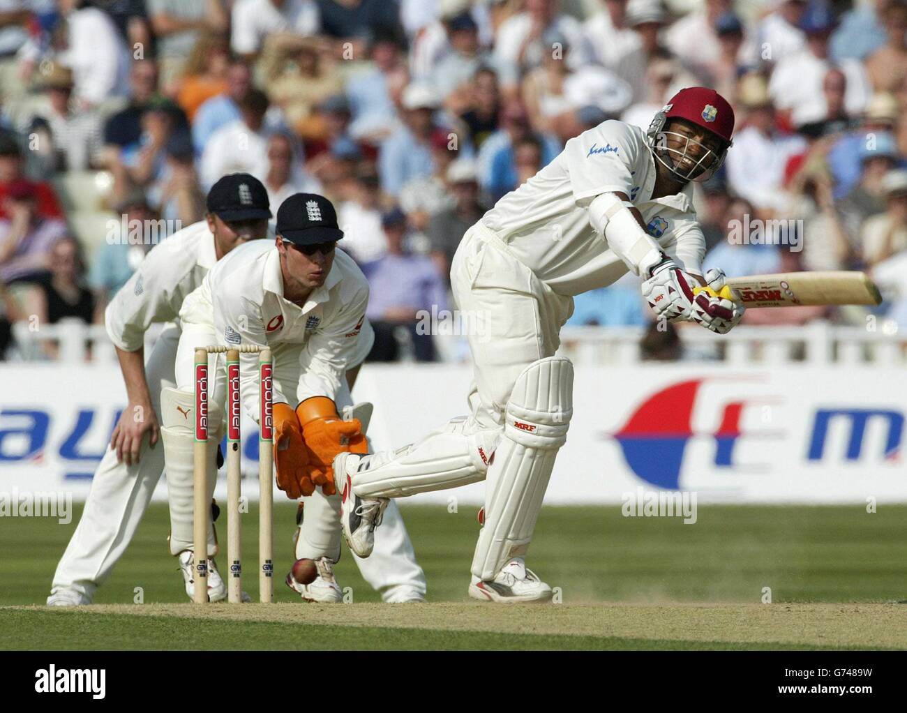 West Indies captain Brian Lara (right) scores four runs of England ...