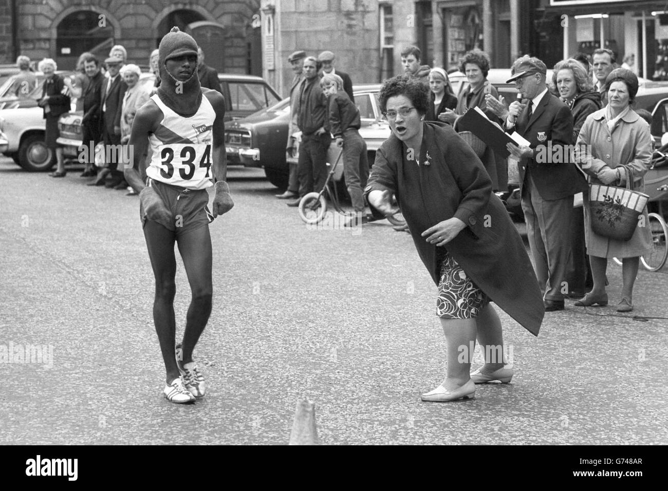 A local woman gives encouragement to Singapore's BKS Maniam during the ...