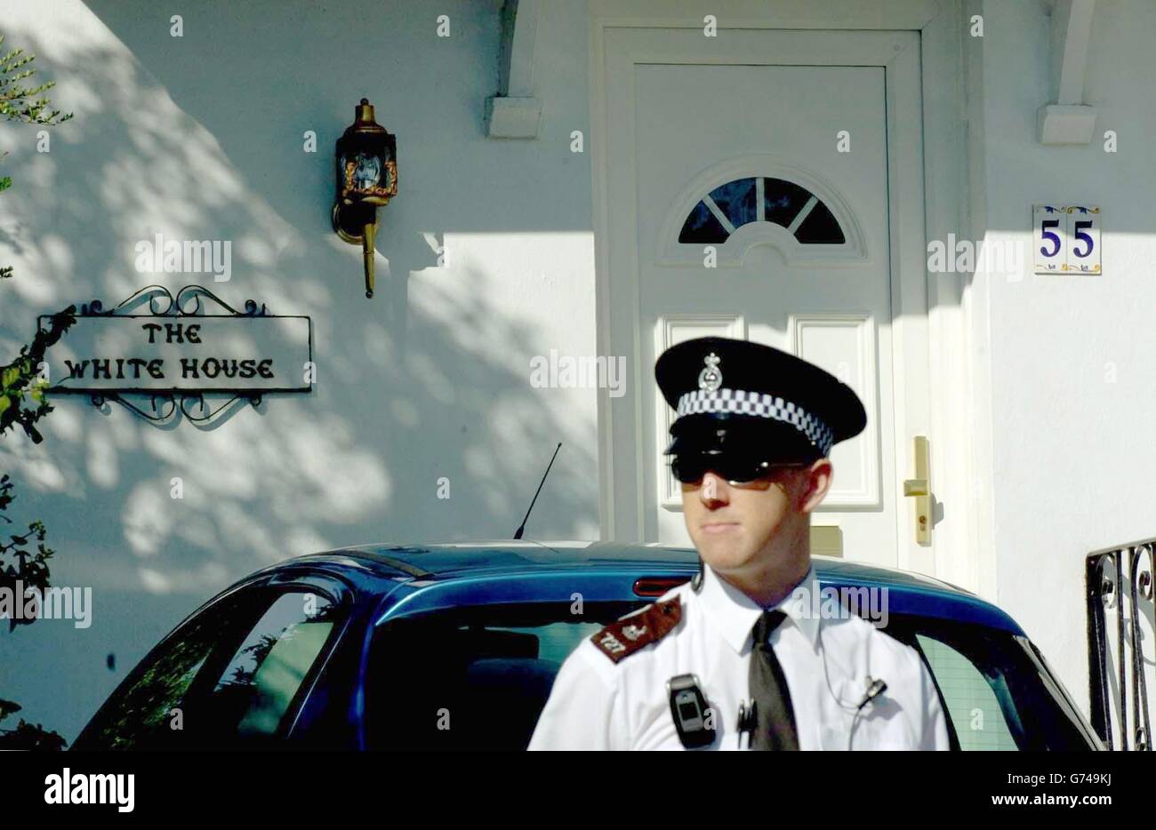 Police officer outside suspects house Stock Photo - Alamy