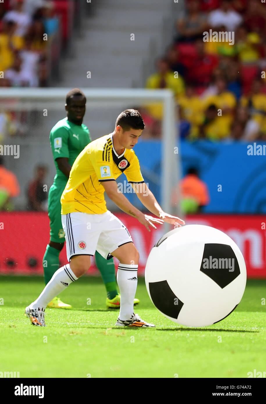 Colombia's James Rodriguez grabs a giant football that has been thrown ...