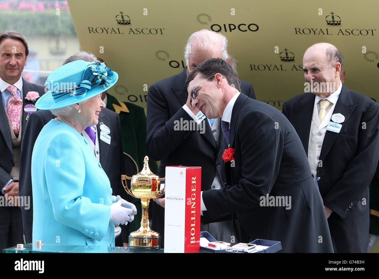 Queen elizabeth ii left presents winning trainer of leading light hi ...