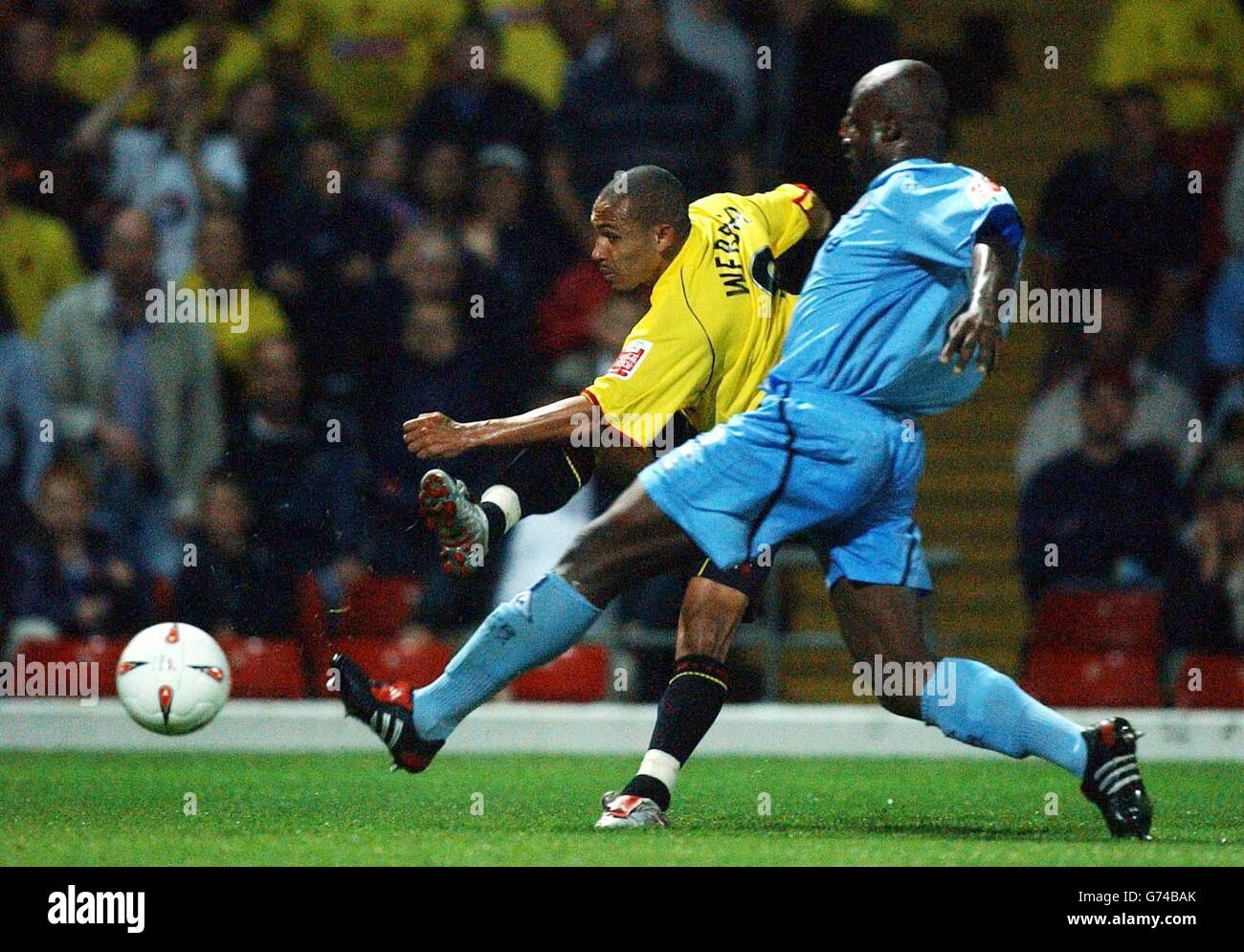 Watford's Danny Webber gets a shot at goal despite QPR's Arthur Gnohere ...