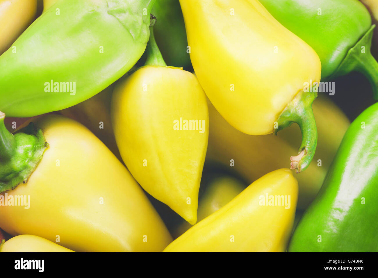 Background of yellow and green peppers, close-up view Stock Photo - Alamy