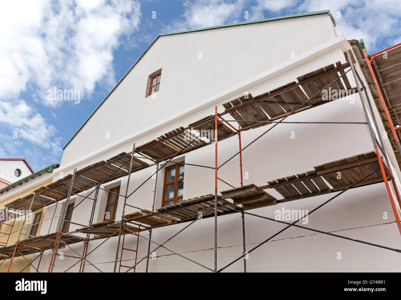 Old building facade with scaffolding under reconstruction Stock Photo ...