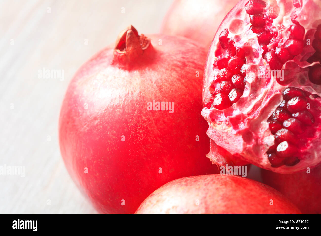 Close up sliced and whole pomegranate on a table Stock Photo - Alamy
