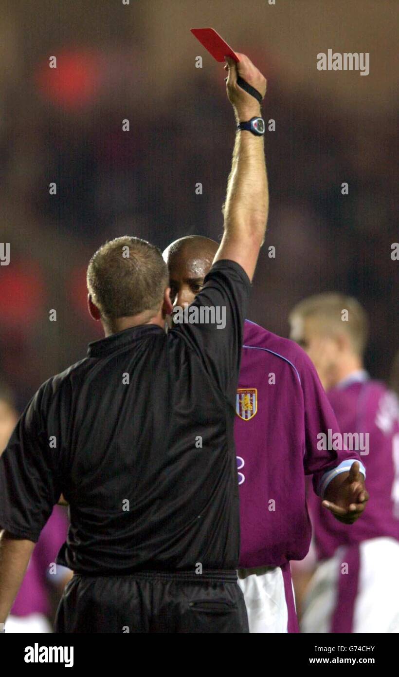 Aston Villa's Dion Dublin (back) argues with referee Steve Dunn as he ...
