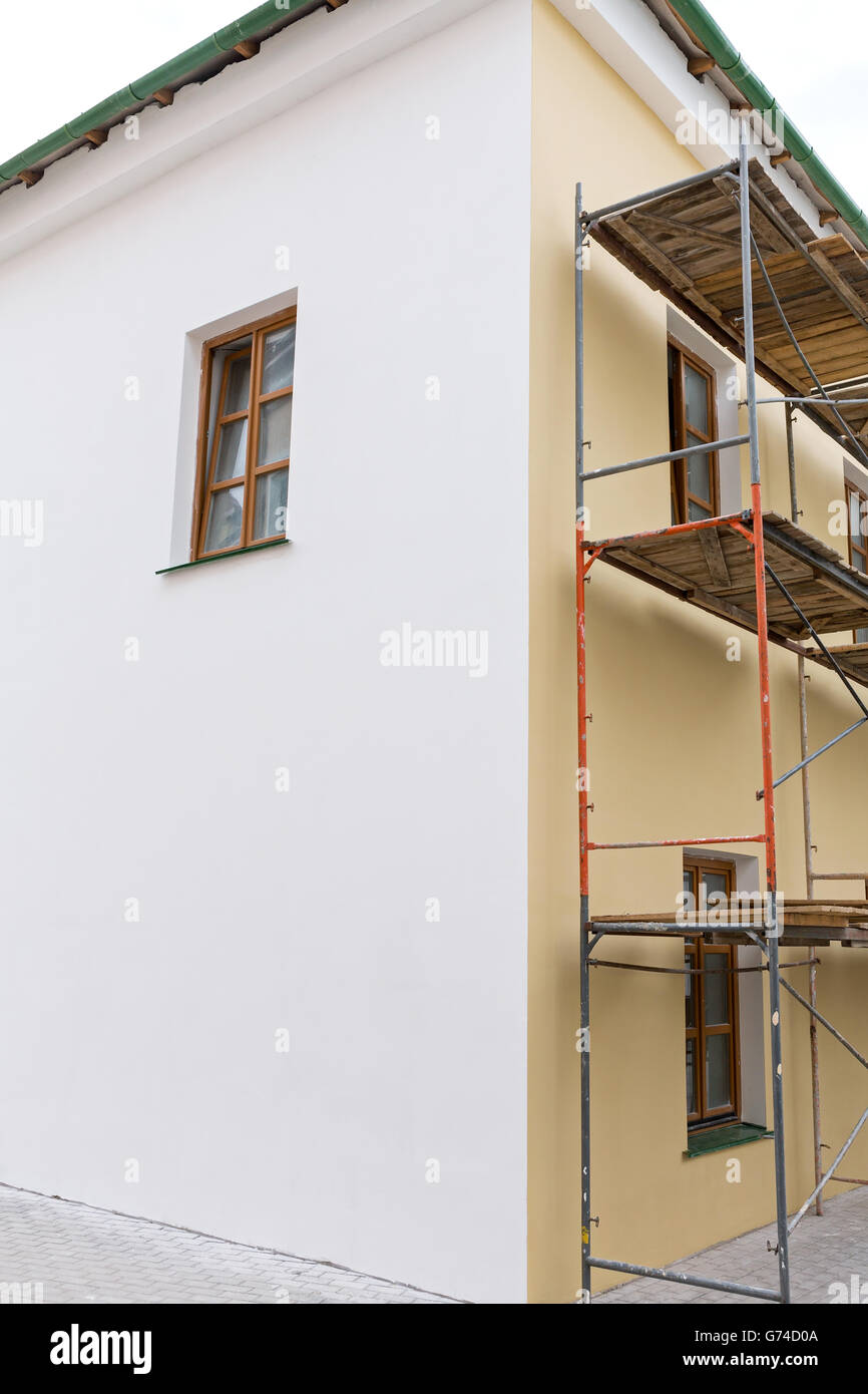 Plaster wall of building under reconstruction with scaffolding Stock ...