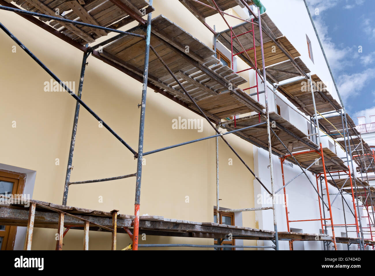 Plaster wall of building under reconstruction with scaffolding Stock ...