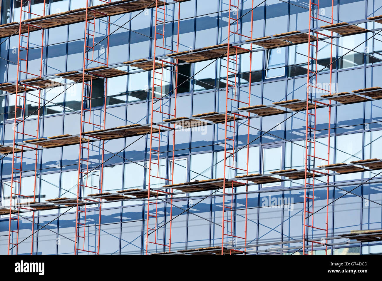 High-rise office building under construction with scaffolding Stock ...