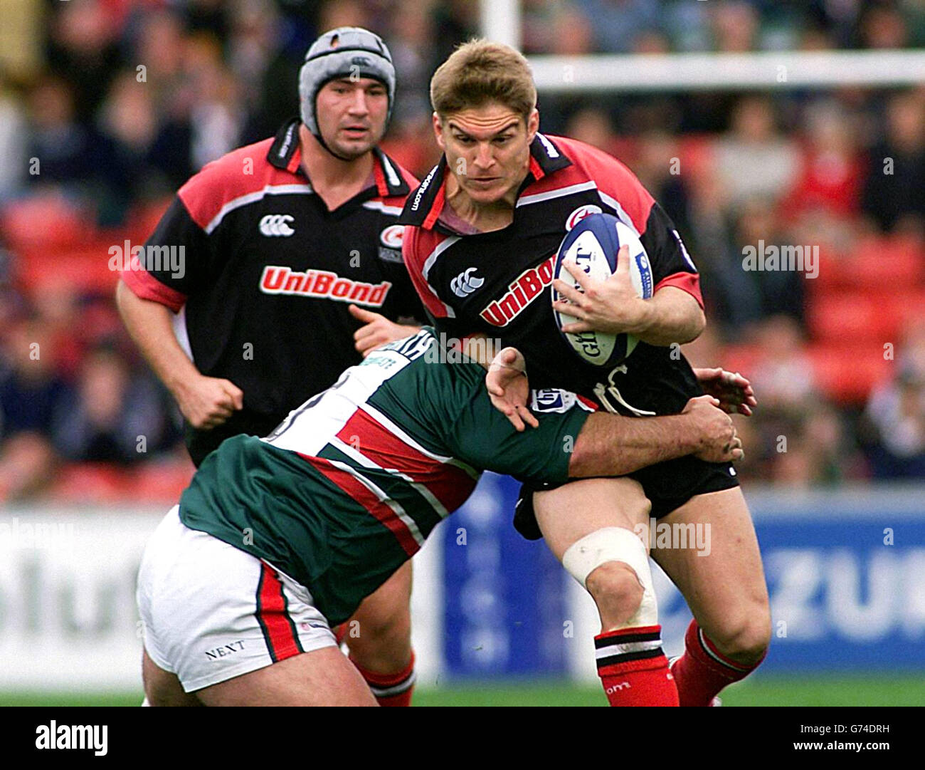 Saracens Tim Horan (right) is tackled by Darren Garforth of Leicester ...