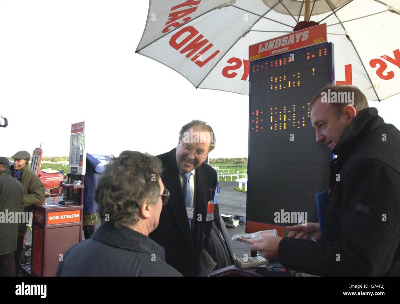 Peter Jones (left, in suit) the Chairman of the Tote jokess with a ...