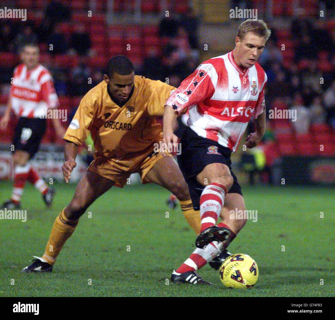 Lincoln City's Tony Battersby (right) holds off Justin Whittle of Hull ...