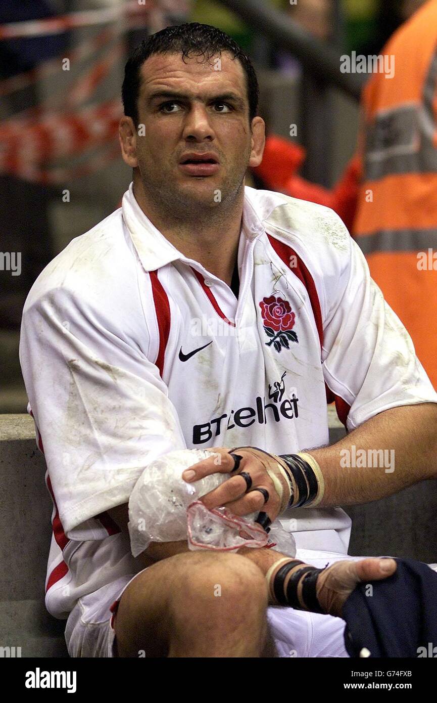 England captain Martin Johnson sits on the bench with an arm injury ...