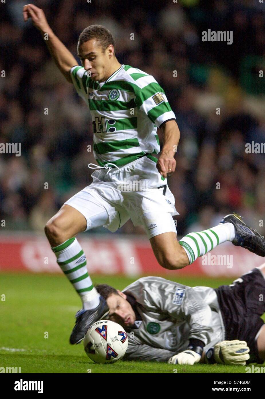 Celtic's Henrik Larsson (left) strides past Hibernian goalkeeper Tony ...