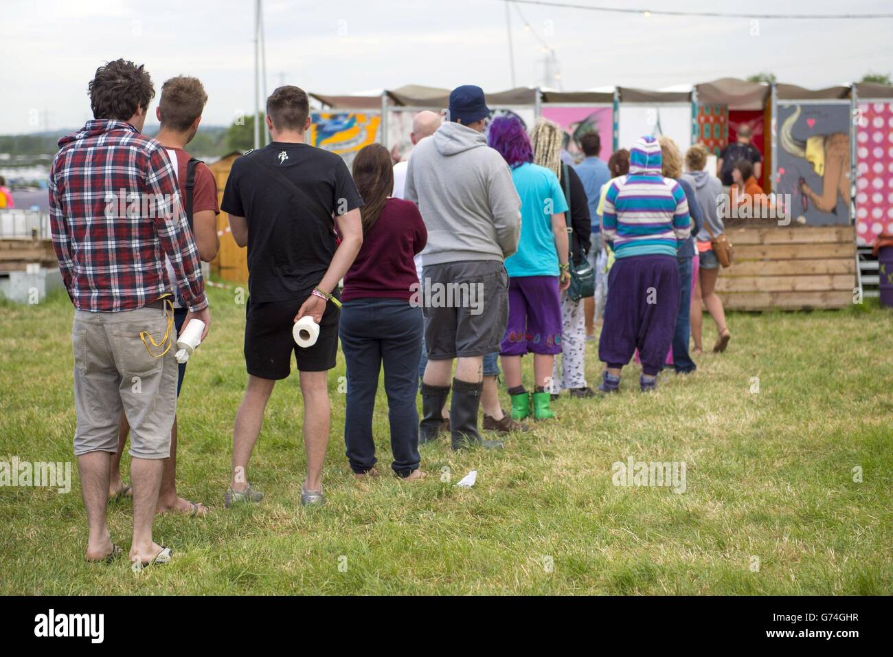 Festival goers queue long drop toilet facilities glastonbury festival ...