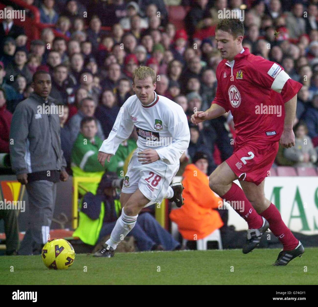 Bristol City captain Louis Carey (right) gets away from Kevin Sharp ...
