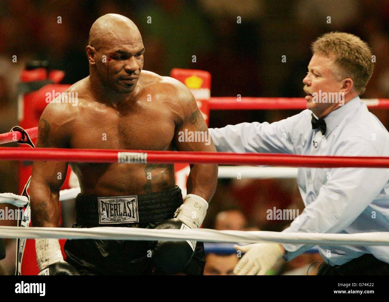 Referee Dennis Alfred (centre) counts out America's Mike Tyson (right ...