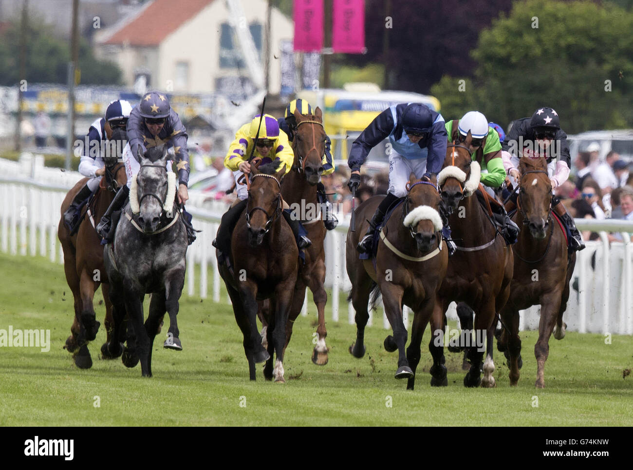 Demora and jockey Ali Rawlinson (centre in blue cap) go on to win The ...