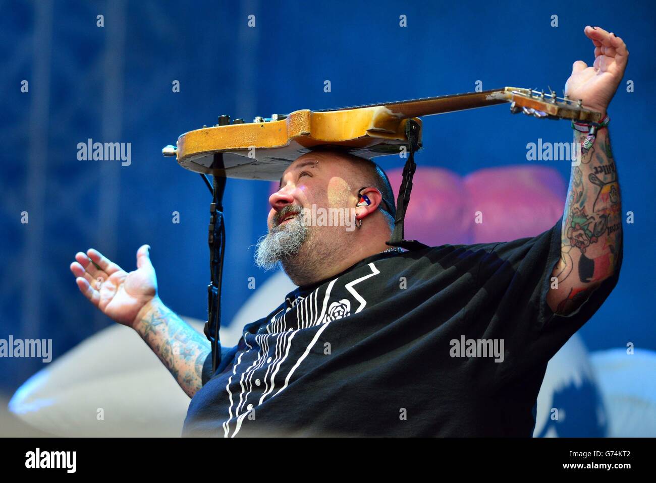 Chris Burney of Bowling For Soup pretends to shelter under his guitar ...