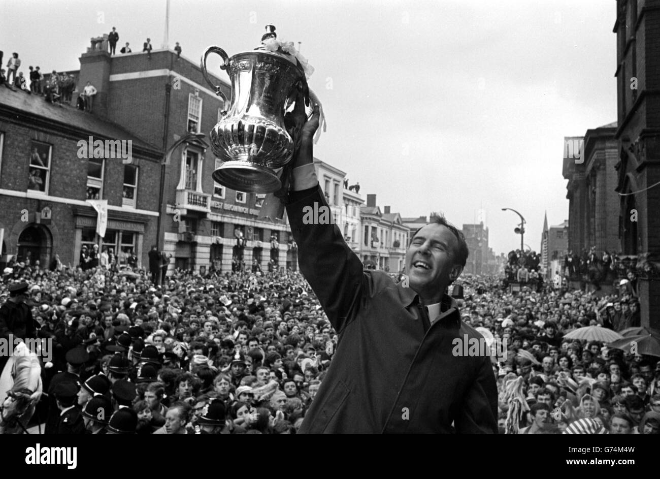Alan Ashman, manager of West Bromwich Albion, holds aloft the FA Cup to ...