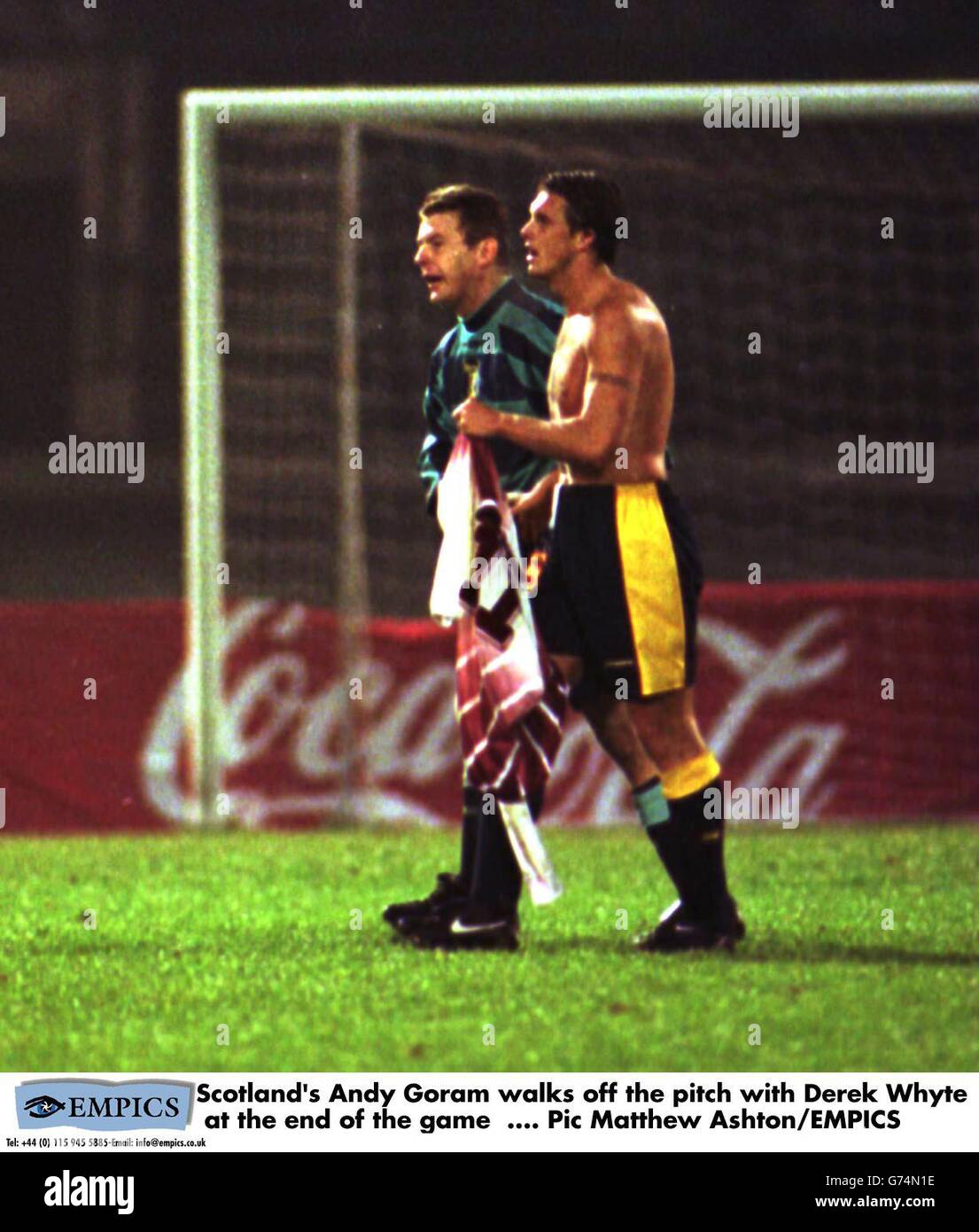 Scotland's Andy Goram walks off the pitch with Derek Whyte at the end ...