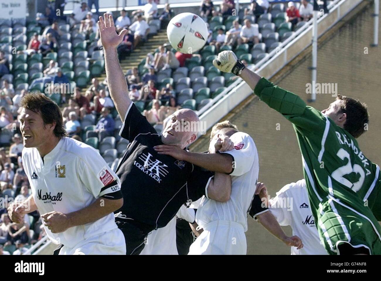 Milton Keynes Dons' Paul Rachubka punches clear to foil Barnsley's ...