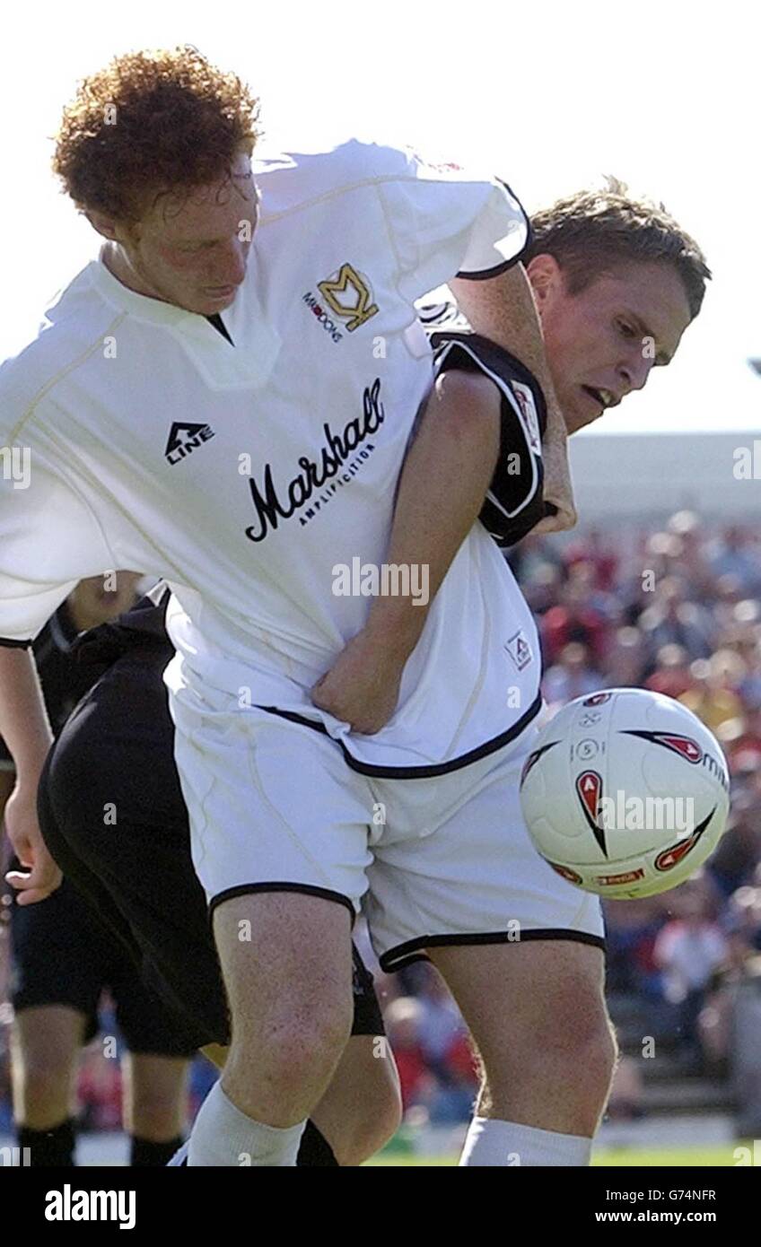 Milton Keynes Dons' Dean Lewington (front) wrestles with Barnsley's ...