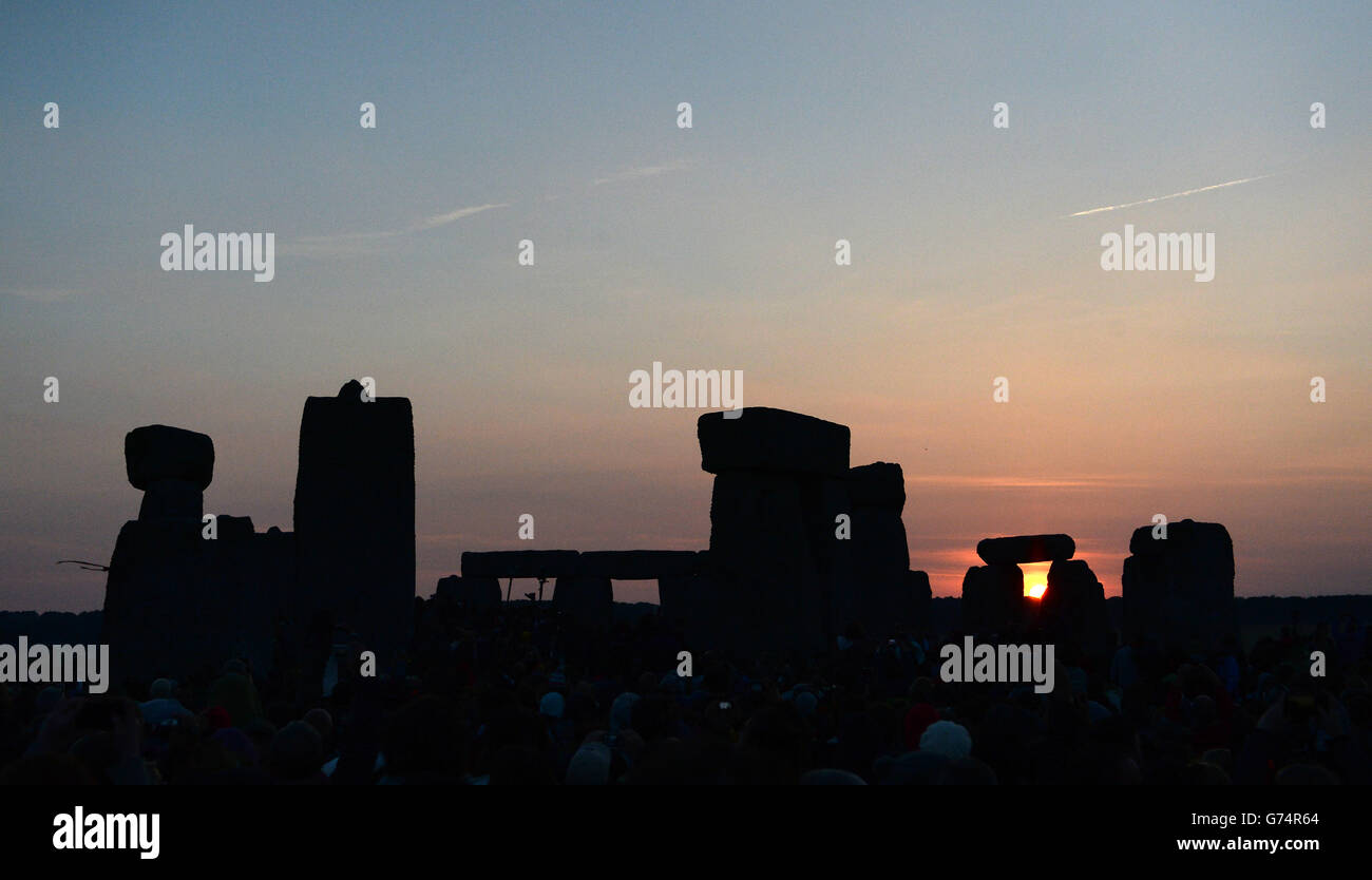 The sun rises above the horizon as dawn breaks behind the stones at ...