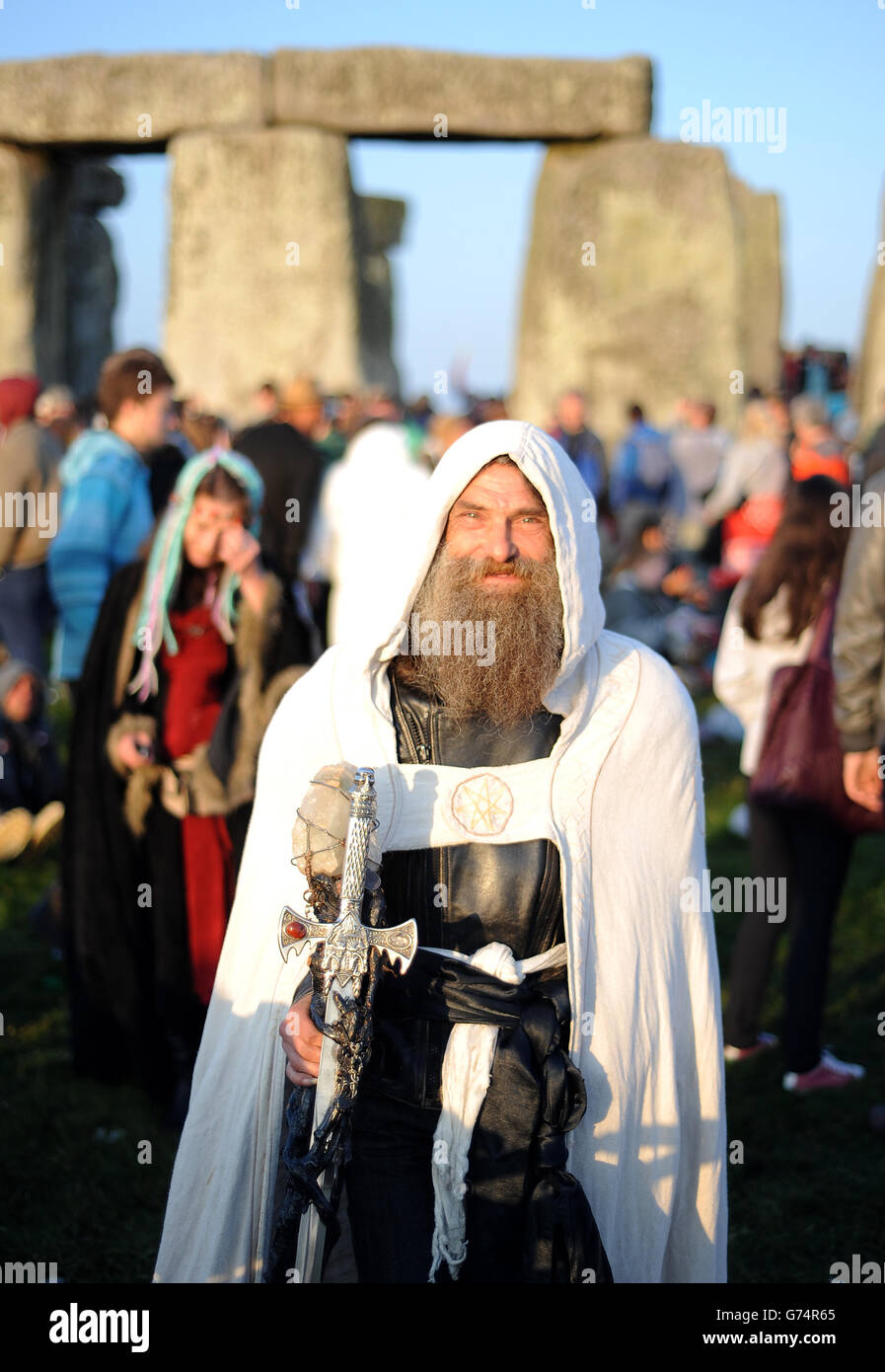 A druid makes his way amongst the stones at Stonehenge in Wiltshire ...