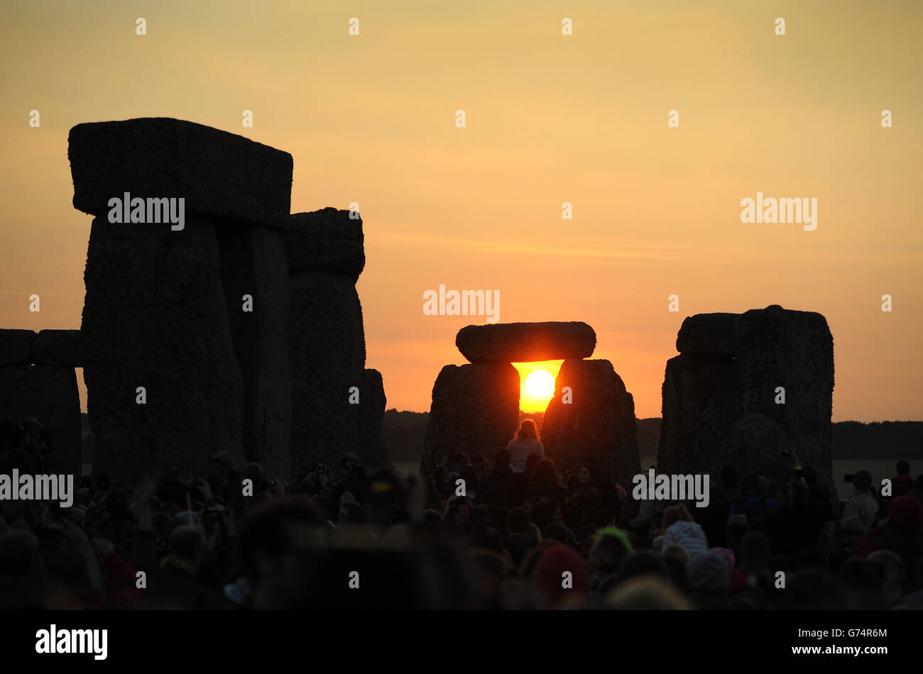 The sun rises above the horizon as dawn breaks behind the stones at ...