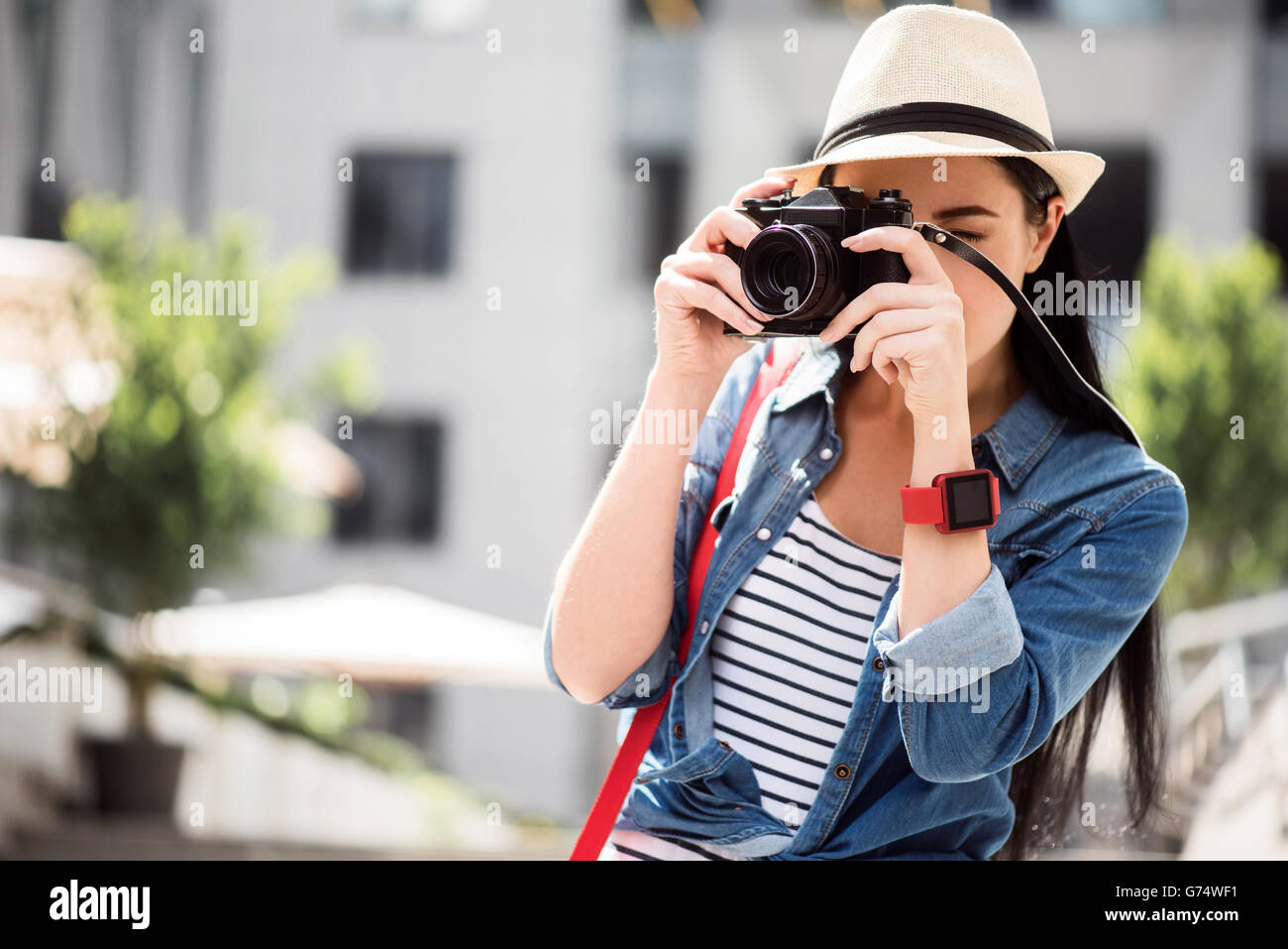 Pleasant woman taking photos Stock Photo - Alamy